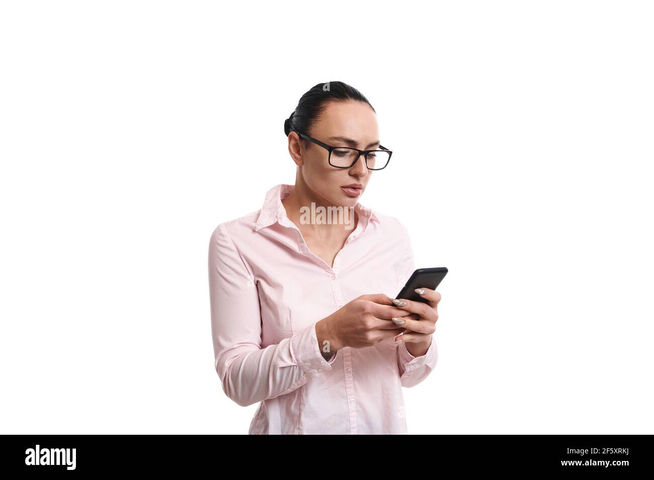 Young woman dressing business casual outfit texting a message on mobile ...