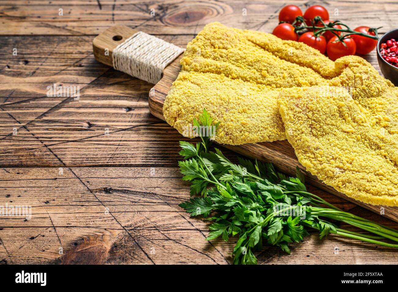 Raw chicken Breaded Weiner Schnitzel. Wooden background. Top view. Copy ...