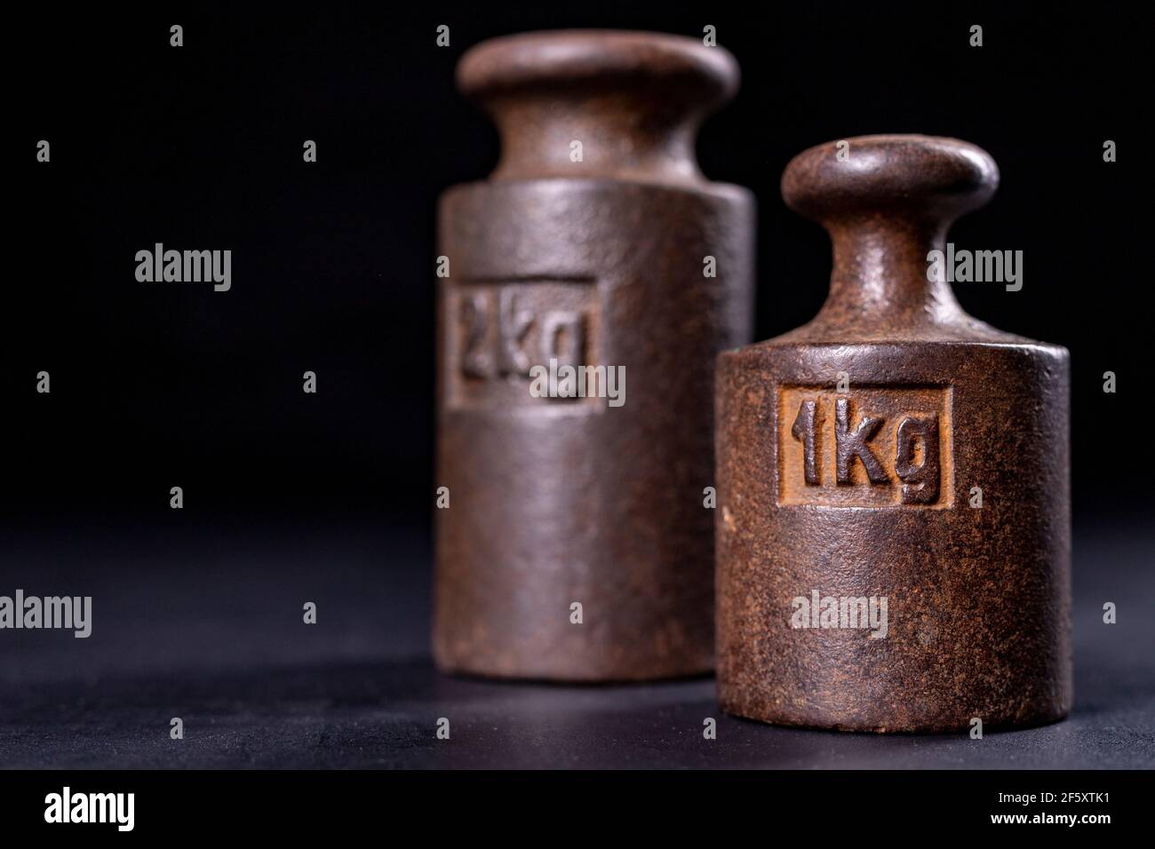 Metal weights for measuring weight. Standard for weighing goods. Dark ...