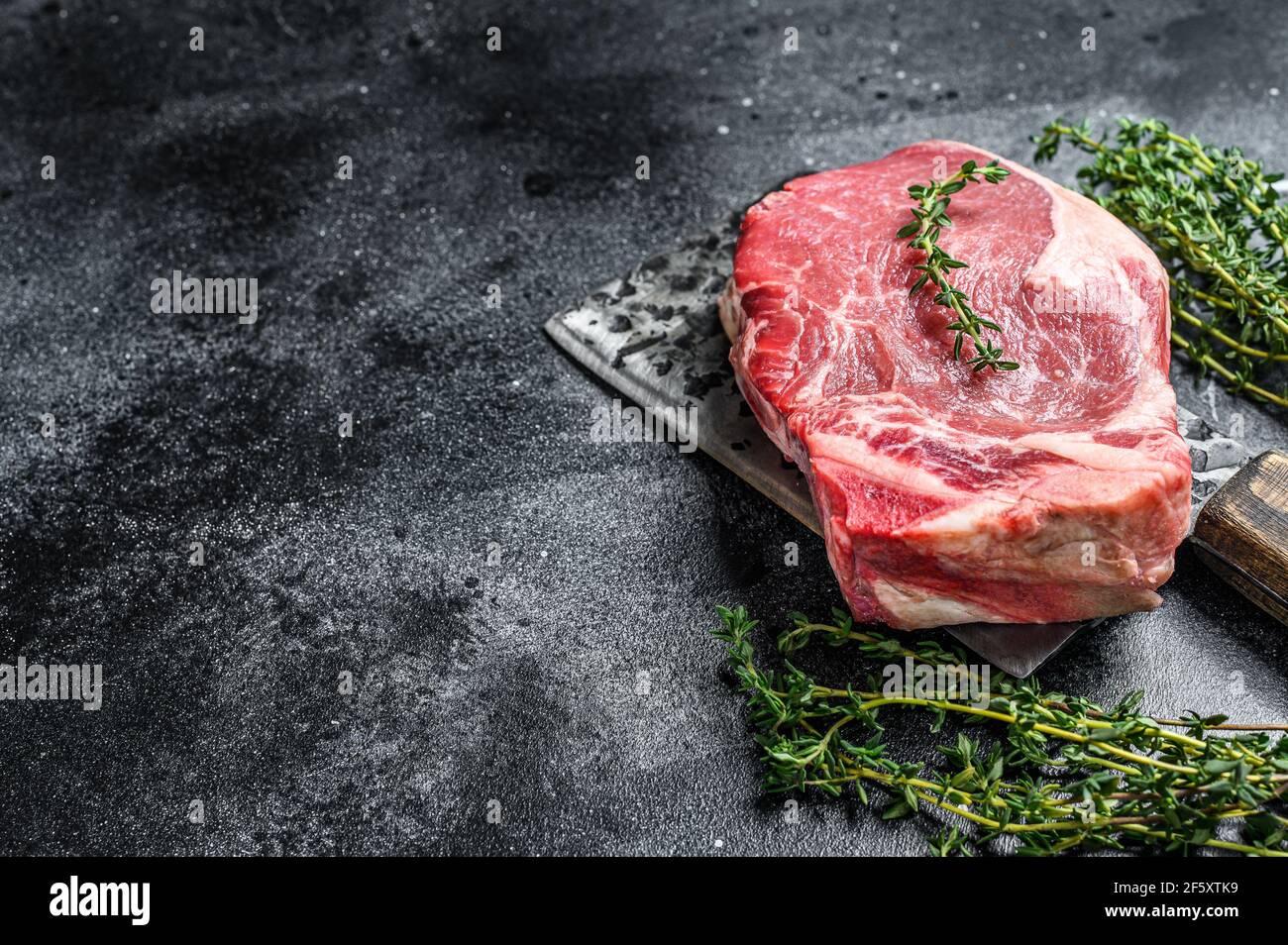 Raw beef club steak. Black ground. Top view. Copy space Stock Photo - Alamy
