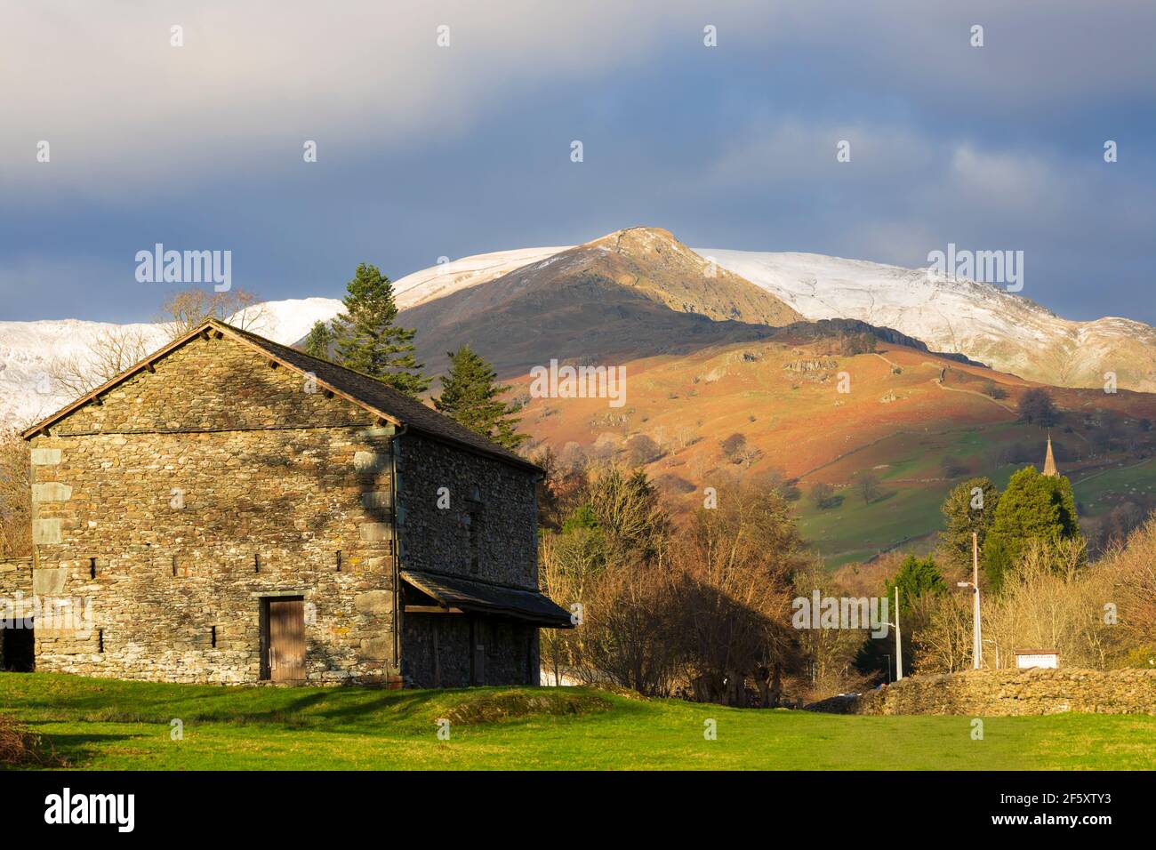 Stone barn and snow topped mountains, Ambleside, Lake District, Cumbria ...