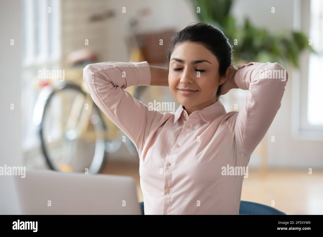 Calm Indian female employee relax at workplace Stock Photo - Alamy