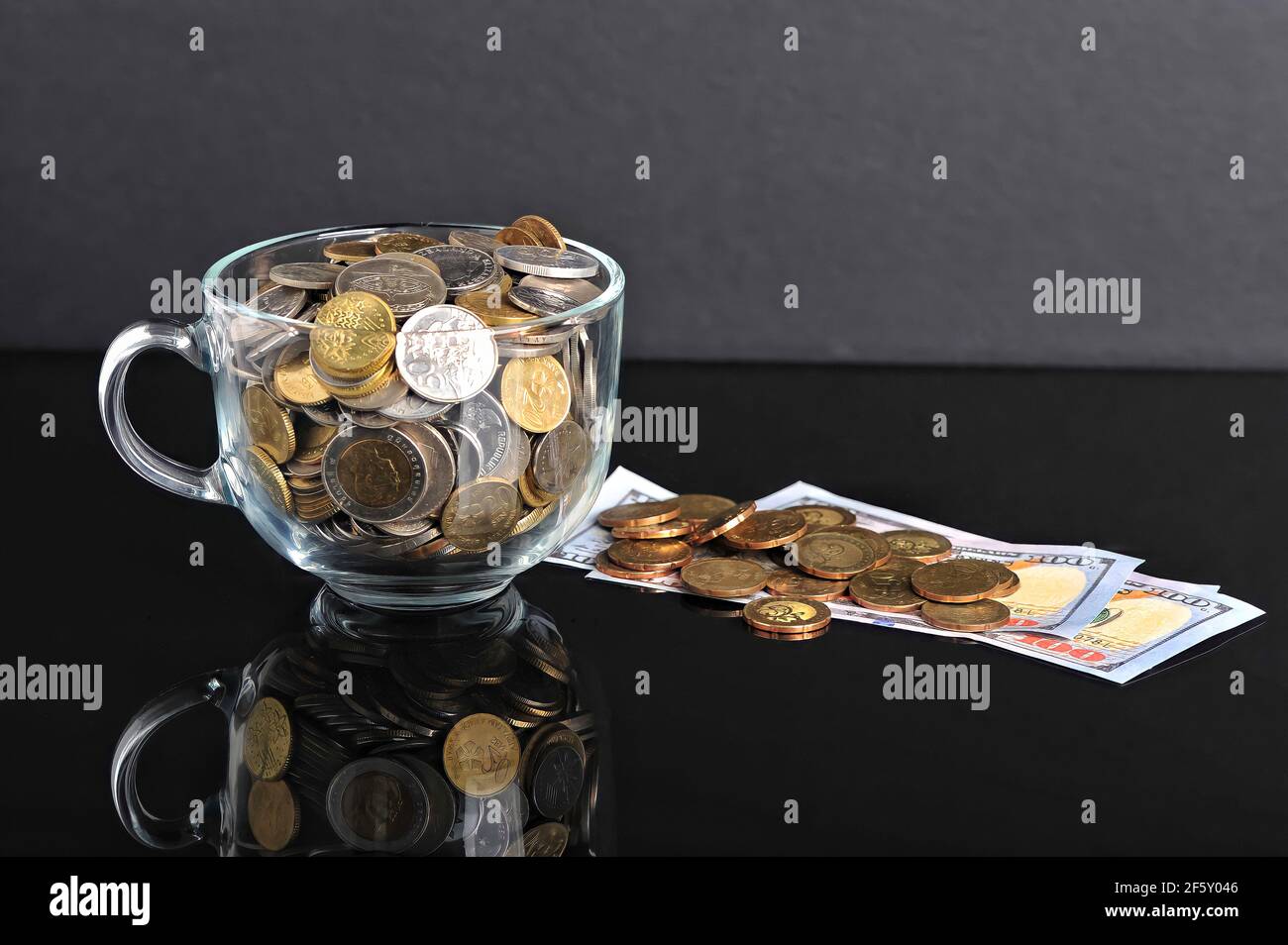 Coins in a cup and fake paper money. Business concept. Selective focus ...