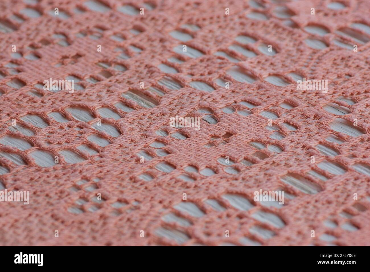 knitted lace. The material is folded randomly on a horizontal surface ...