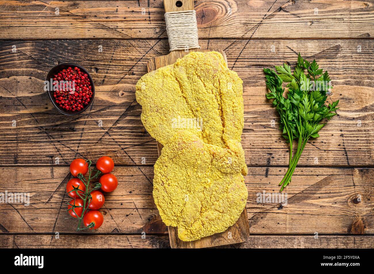 Raw chicken Breaded Weiner Schnitzel. Wooden background. Top view Stock ...