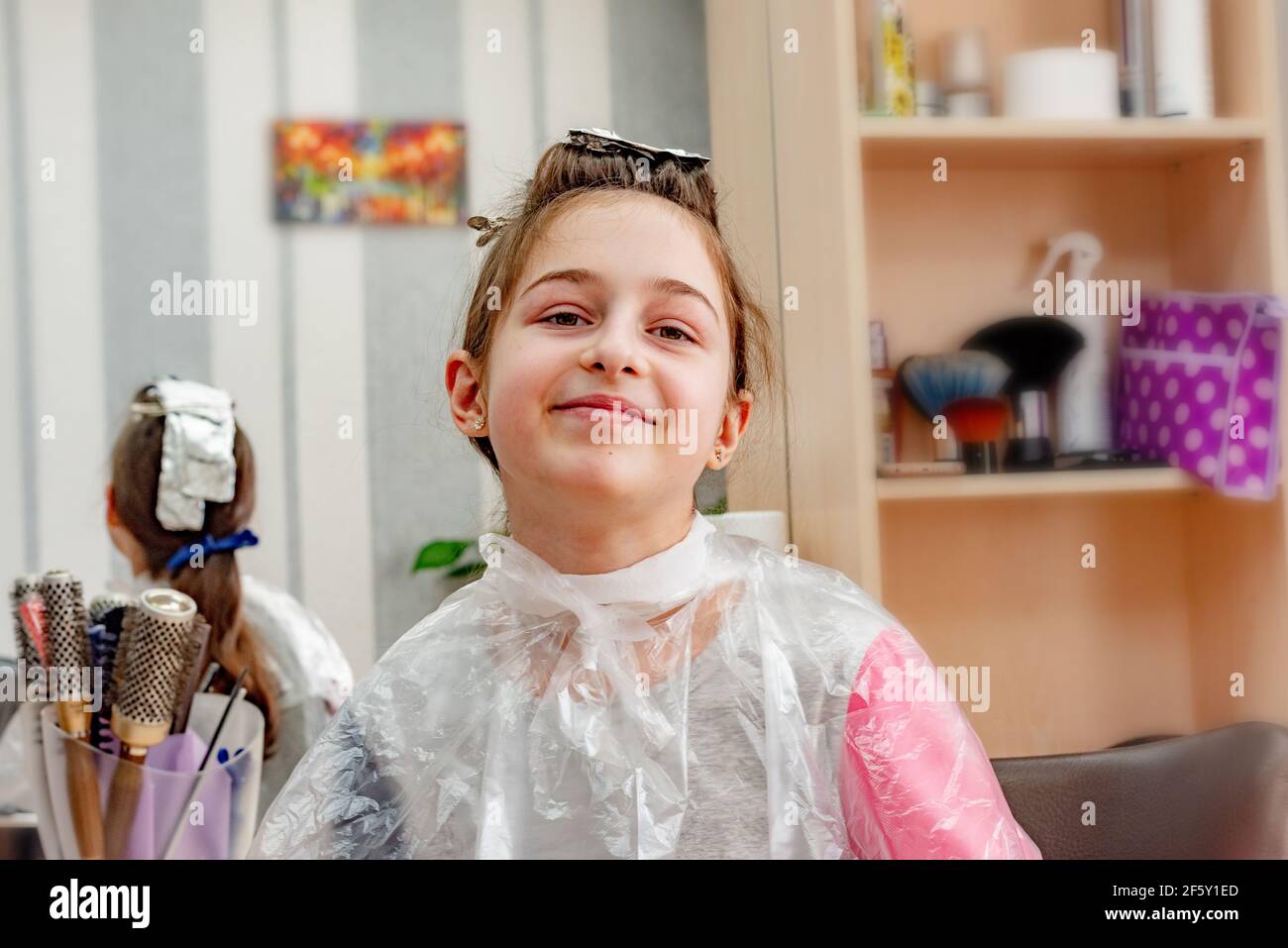 Teenage girl in a beauty salon on hair coloring and a haircut. Beauty ...