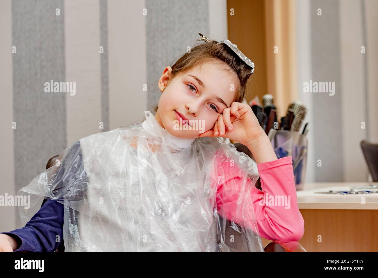 Teenage girl in a beauty salon on hair coloring and a haircut. Beauty ...