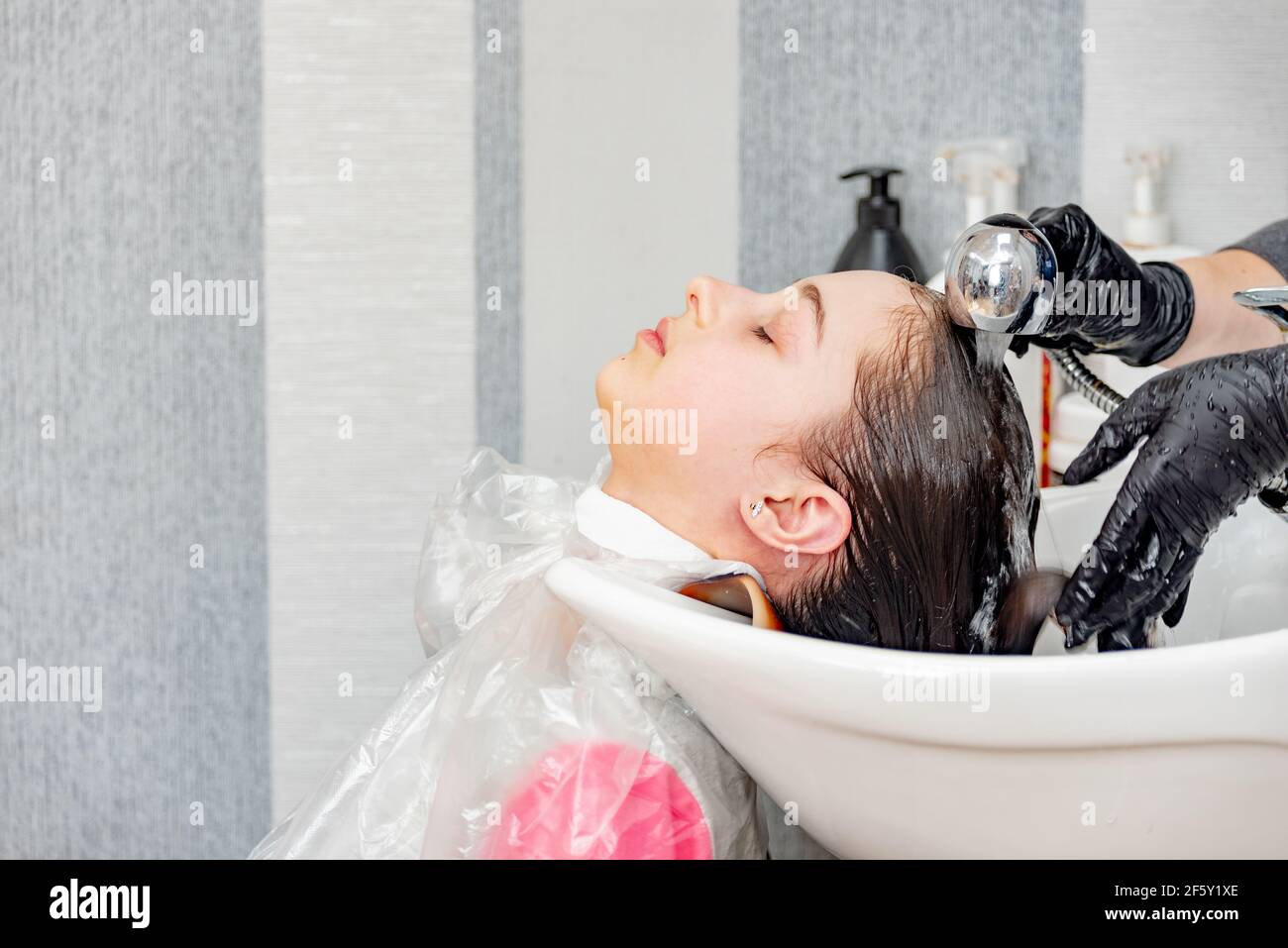 Teenage girl in a beauty salon on hair coloring and a haircut. Beauty ...