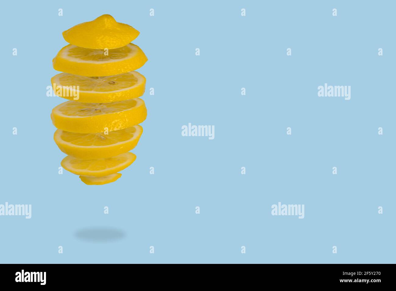 Floating levitating fresh lemon on pastel blue background. Vitamins ...