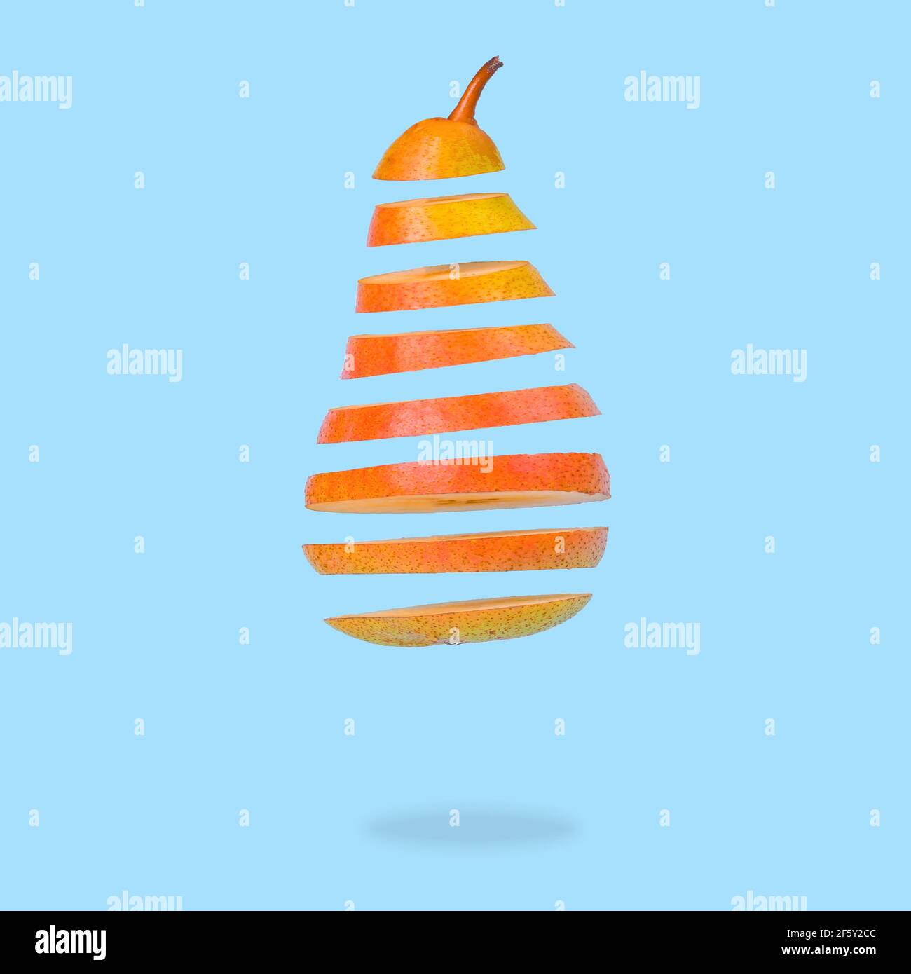 Minimal idea with Floating levitating ripe pear on pastel blue ...