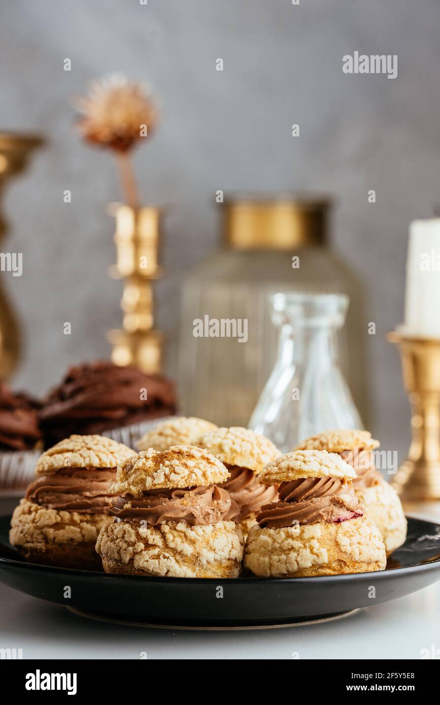 shu buns with chocolate buttercream Stock Photo - Alamy