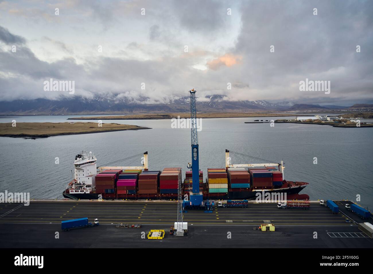 Barge moored in shipping port of cold city Stock Photo - Alamy