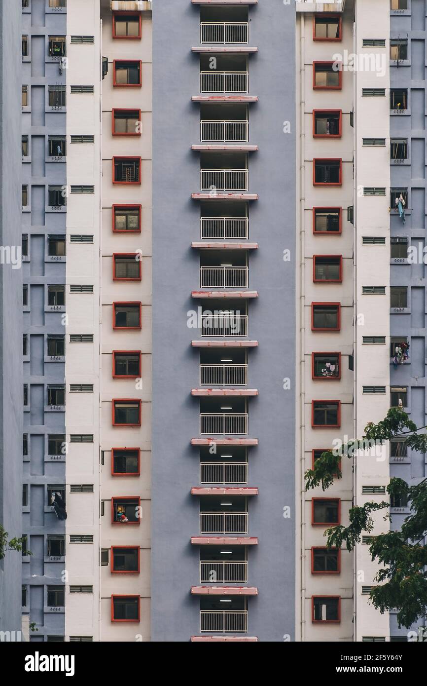 Front view of an old dense apartment complex exterior with moody tones ...