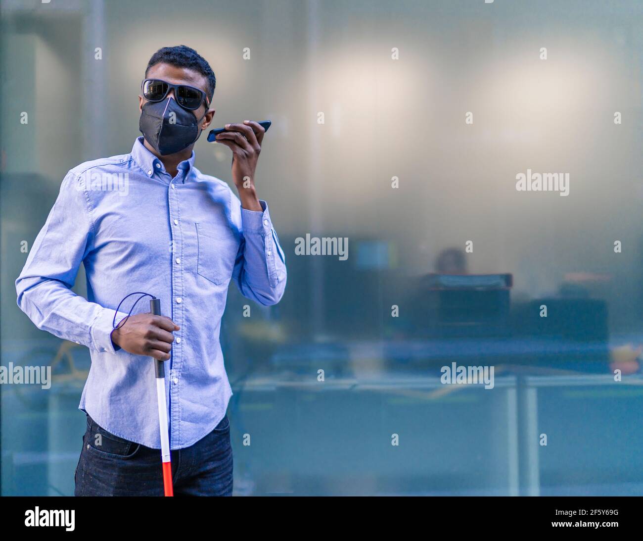 young blind african man talking on his smartphone Stock Photo - Alamy