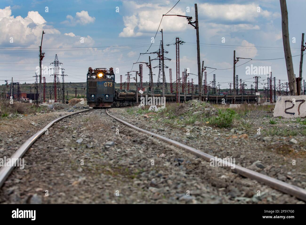 Rudny/Kazakhstan - May 14 2012: Open-pit mining iron ore. Railway train ...