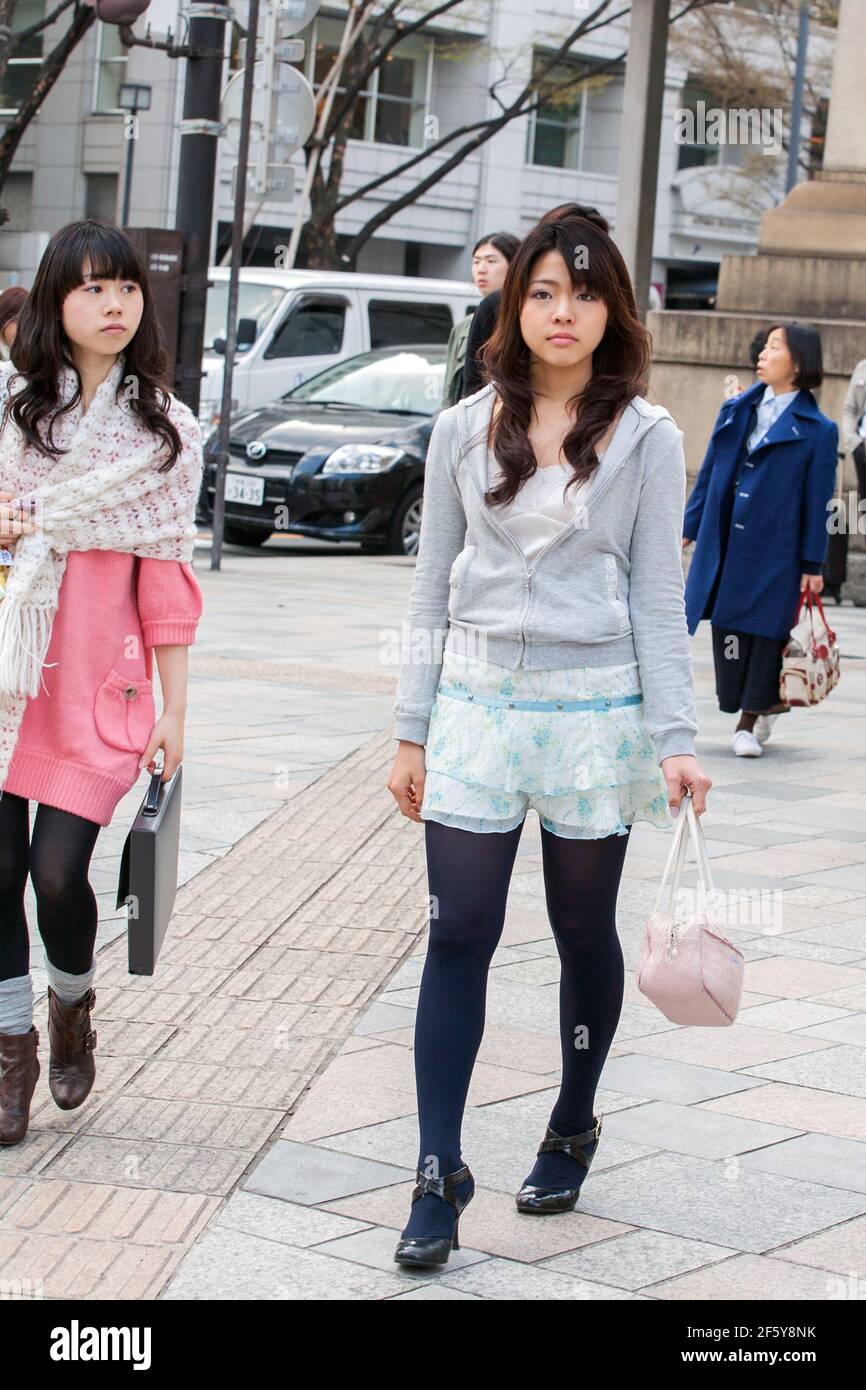 Pretty young Japanese female dressed in floral short skirt and black ...
