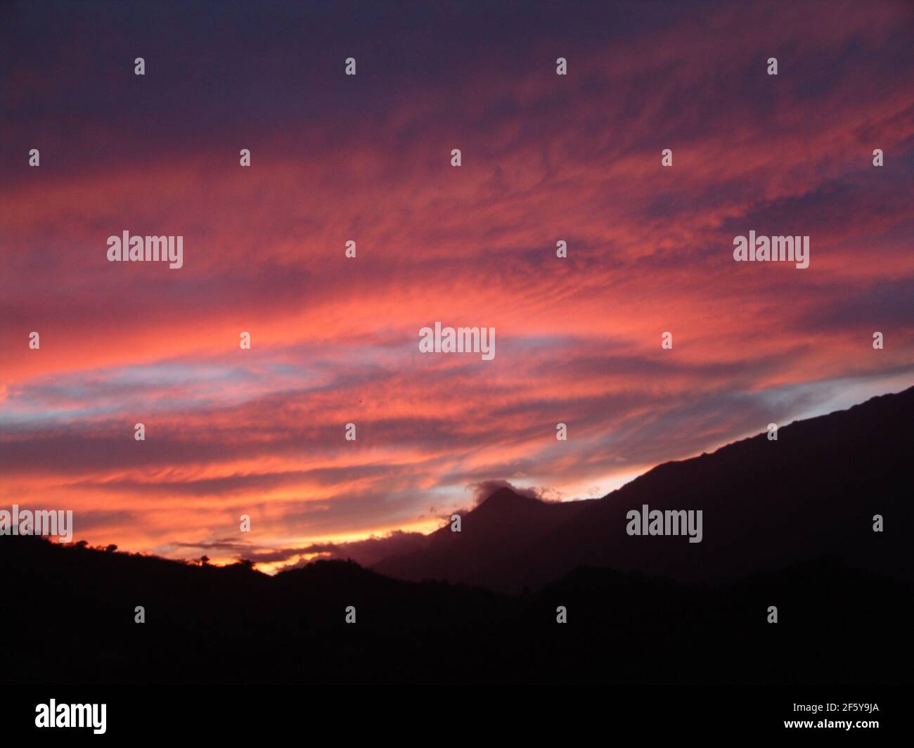 Dramatic sunset skyscape over the silhouette of hills Stock Photo - Alamy