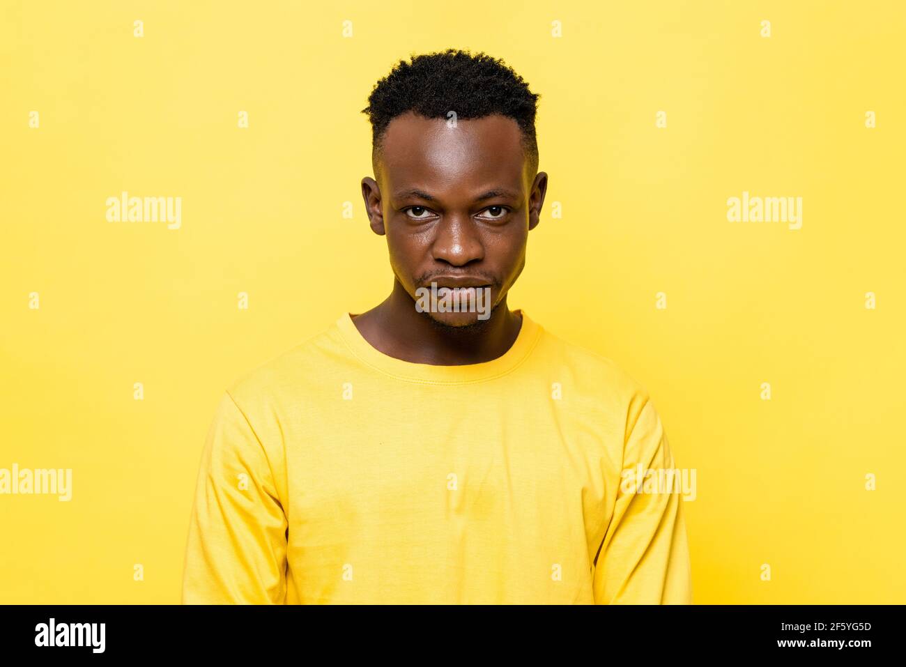 Young African man face on isolated yellow studio background Stock Photo ...