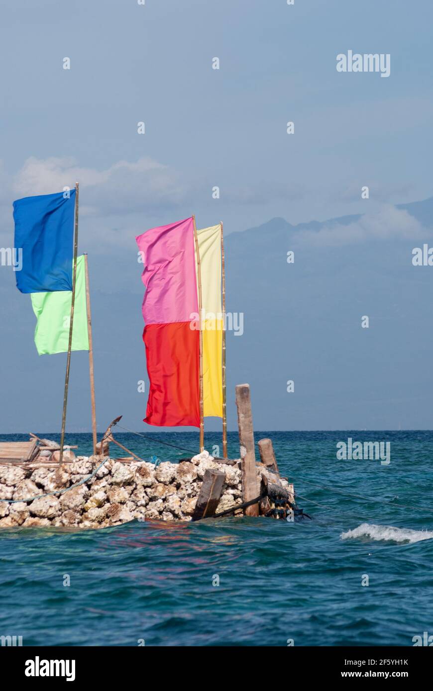 Colorful flags waving against strong winds by the coast Stock Photo - Alamy