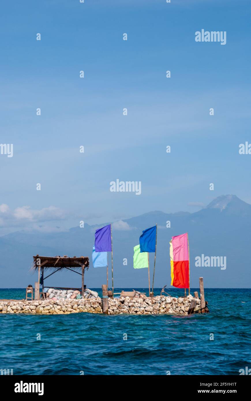 Colorful flags waving against strong winds by the coast Stock Photo - Alamy