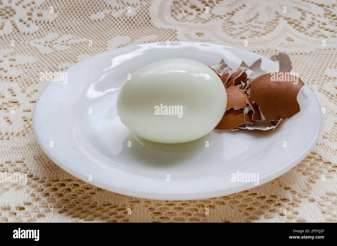 Stripped Whole Boiled Egg And Crumbled Sell In Saucer Stock Photo - Alamy