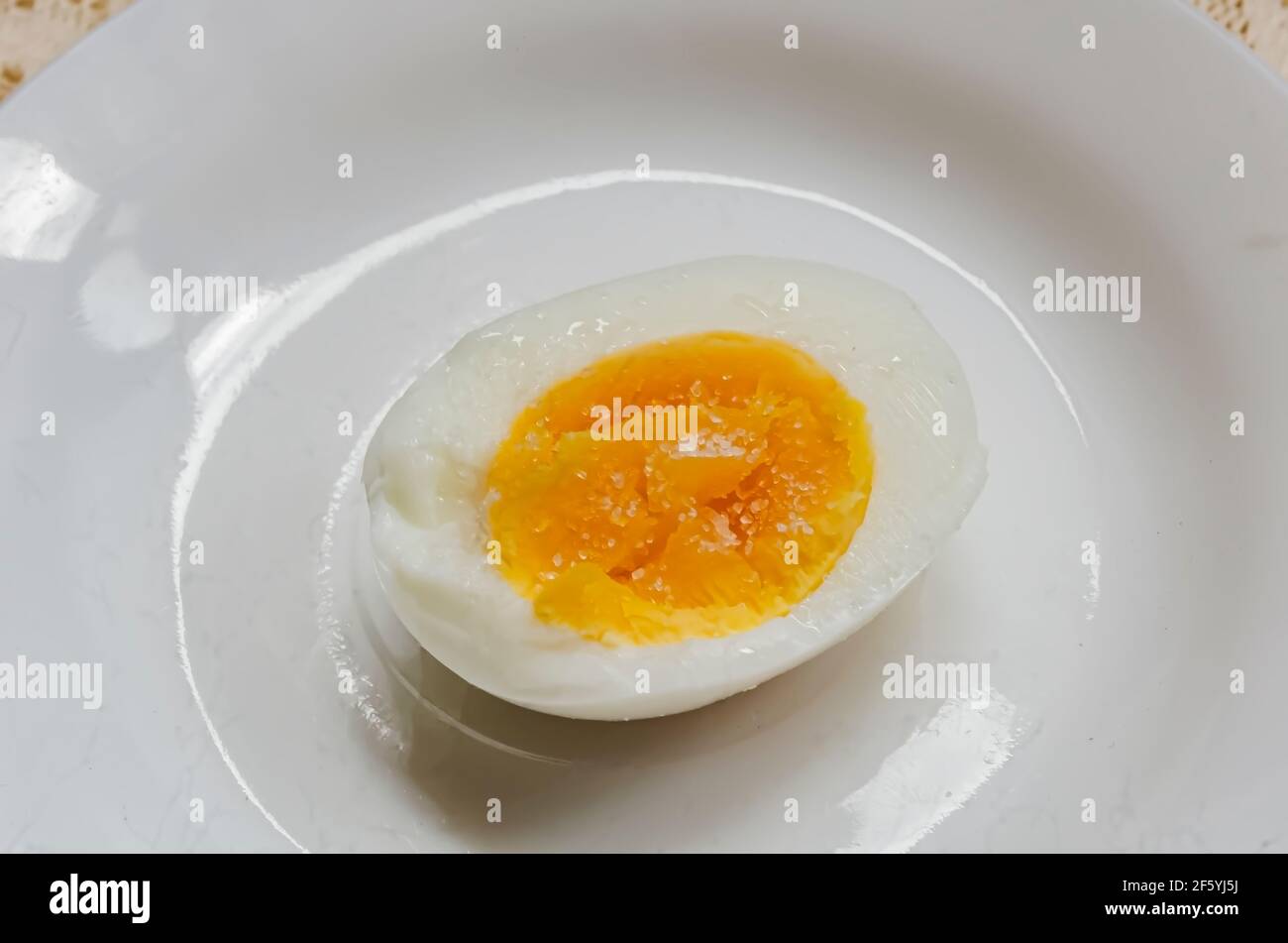 Half Stripped Boiled Egg Albumen And Yolk With Salt Stock Photo - Alamy