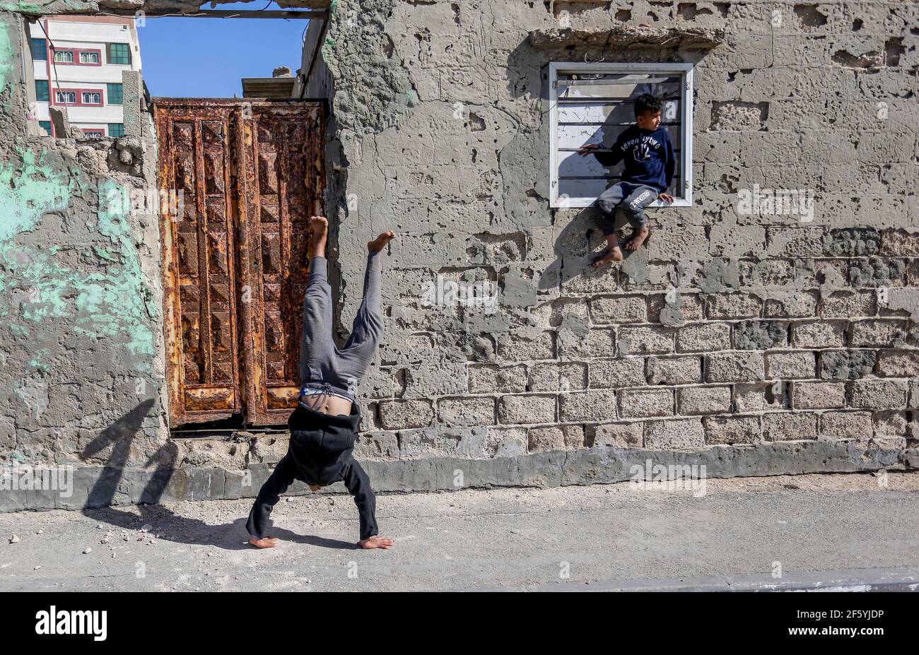 Palestinian children play outside their home at Beach camp in the ...
