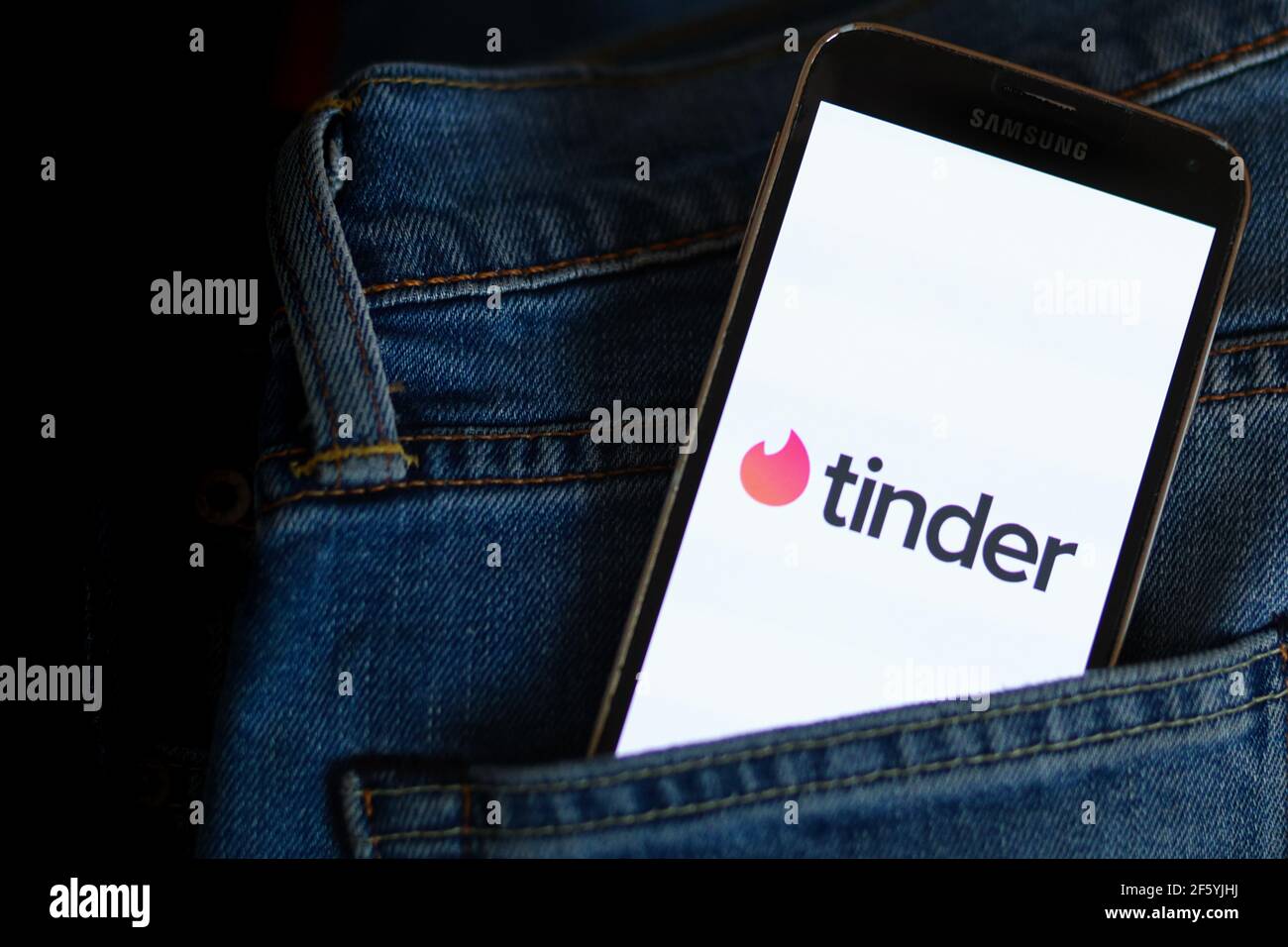 In this photo illustration, a Tinder dating app logo seen displayed on ...