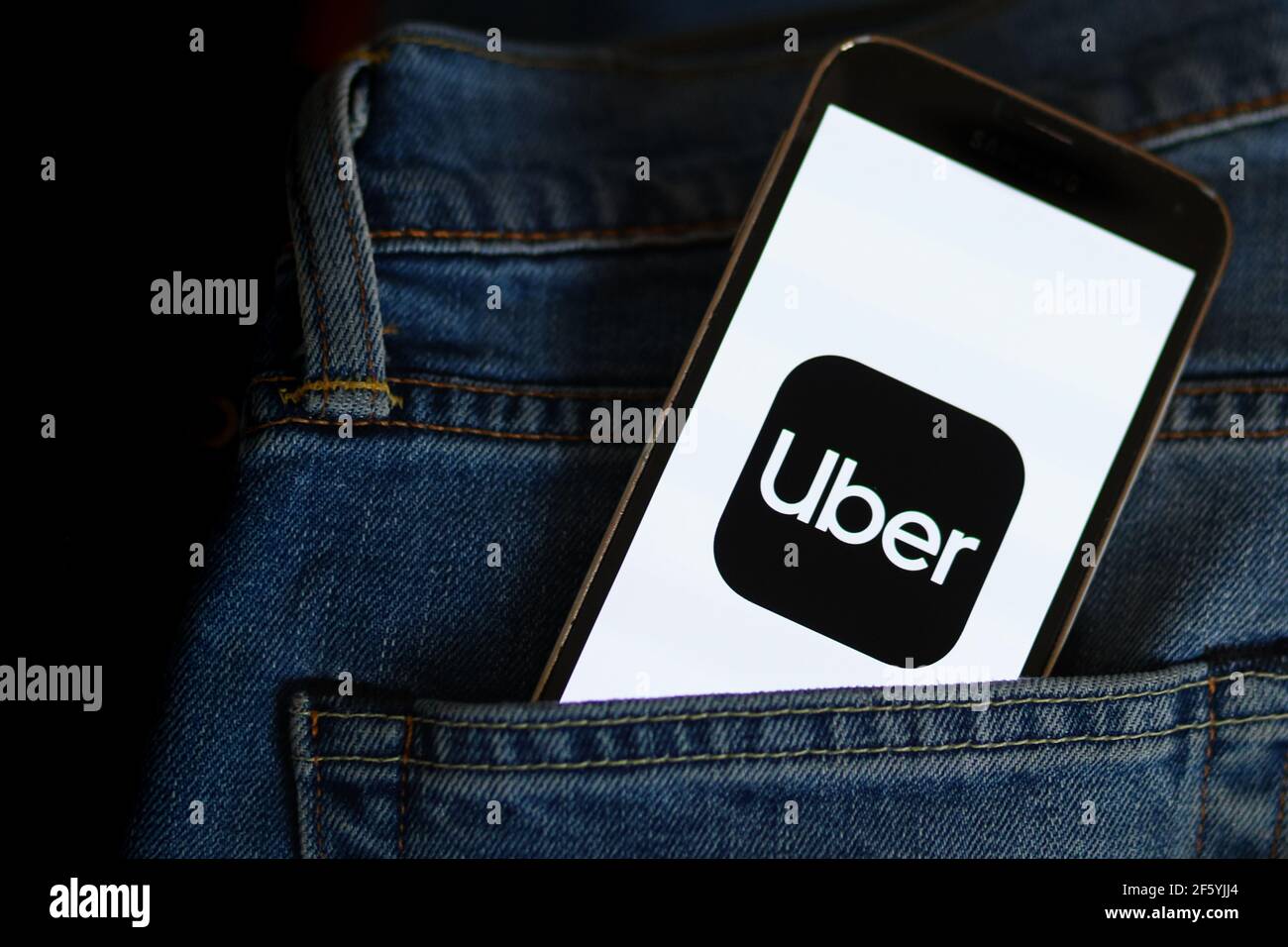 In this photo illustration, a Uber logo seen displayed on a smartphone ...