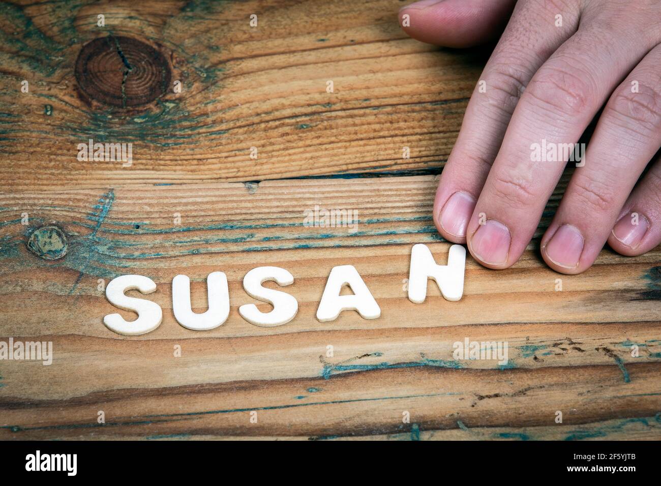 SUSAN. Name of women and girls. White letters of the alphabet on a ...