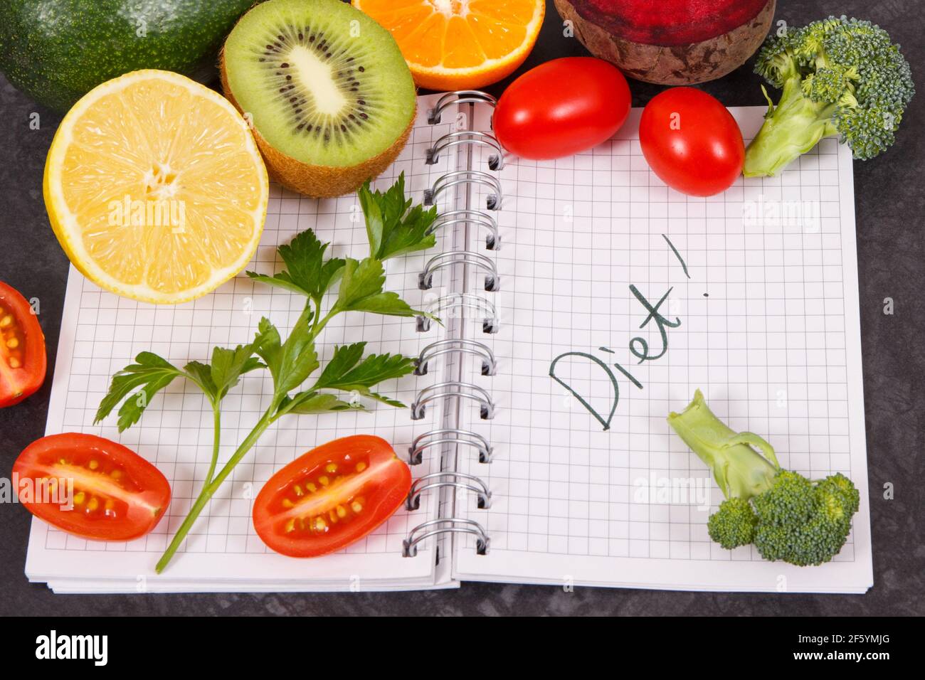 Word diet written in notepad and fresh ripe fruits with vegetables ...