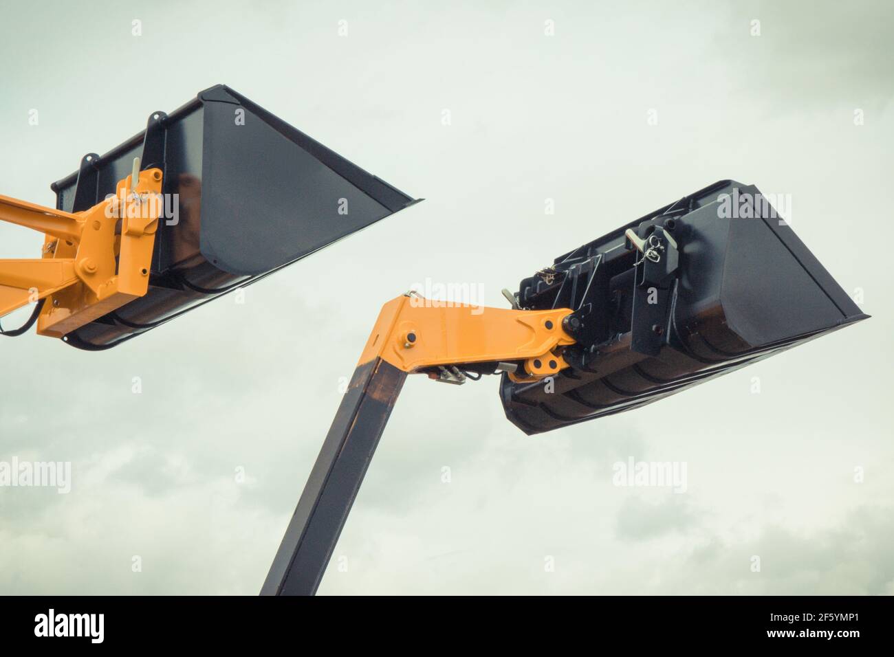 Shovel of excavator or bulldozer on sky background. Detail of part of ...