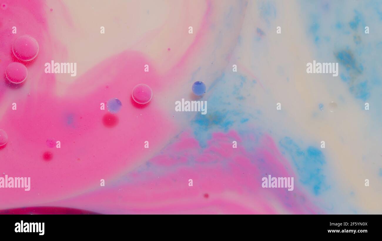 Top view movement of pink oil ink drops bubbles, multicolored artistic ...