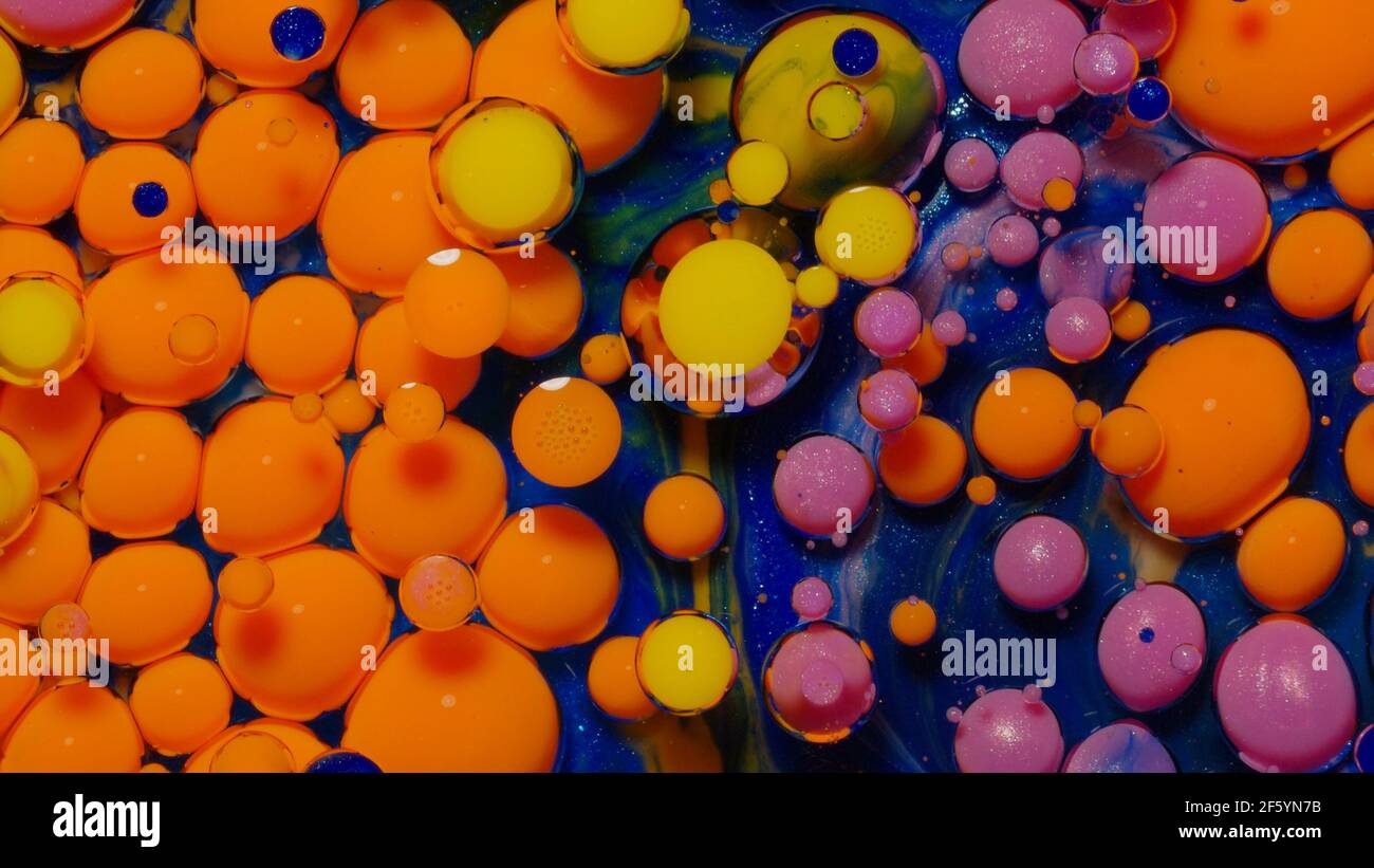 Bubbles float in liquid paint, mixing ink, oil and milk, abstract ...