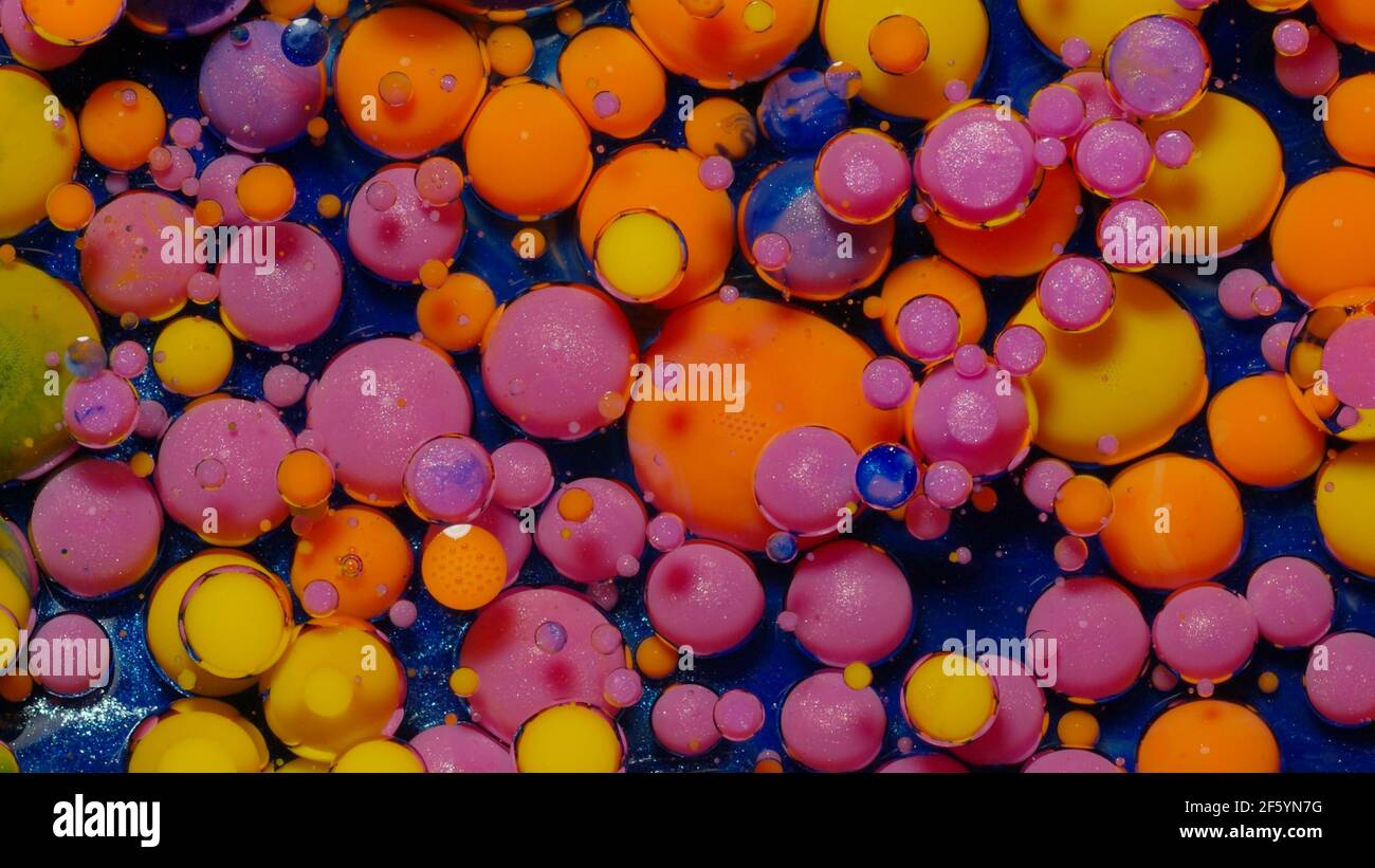 Ink bubbles mixed with liquid substance of oil, milk, soap, bright ...