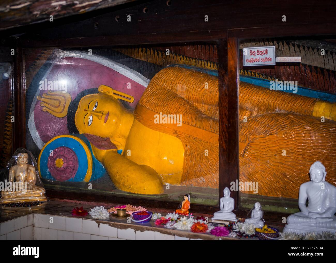 Ancient colorful statue of the sleeping Buddha in Ella Temple in Ella ...
