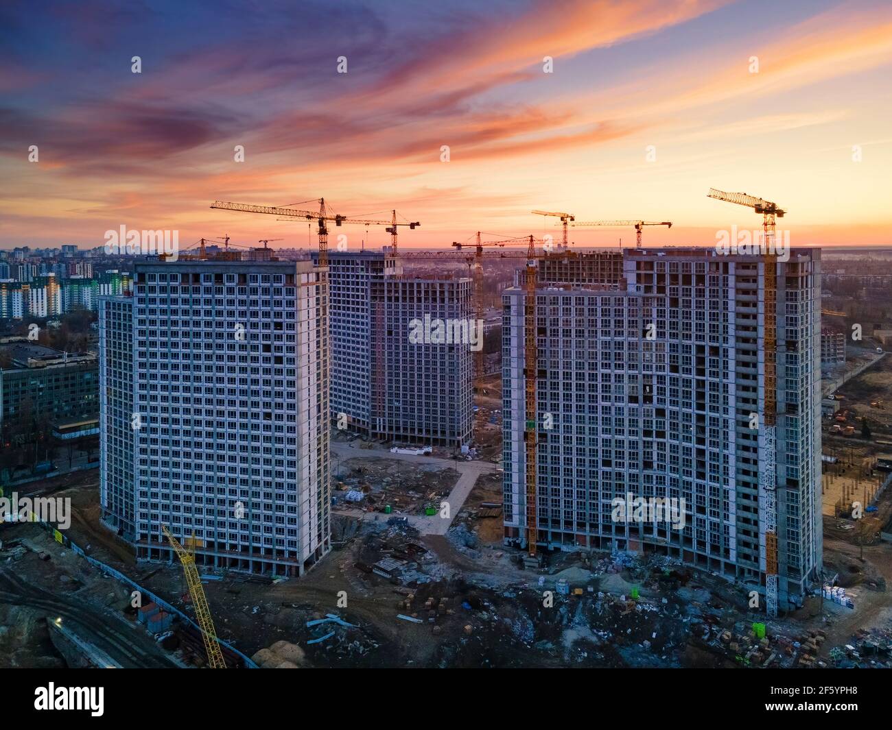 Colorful sunset above construction site of the new real estate city ...