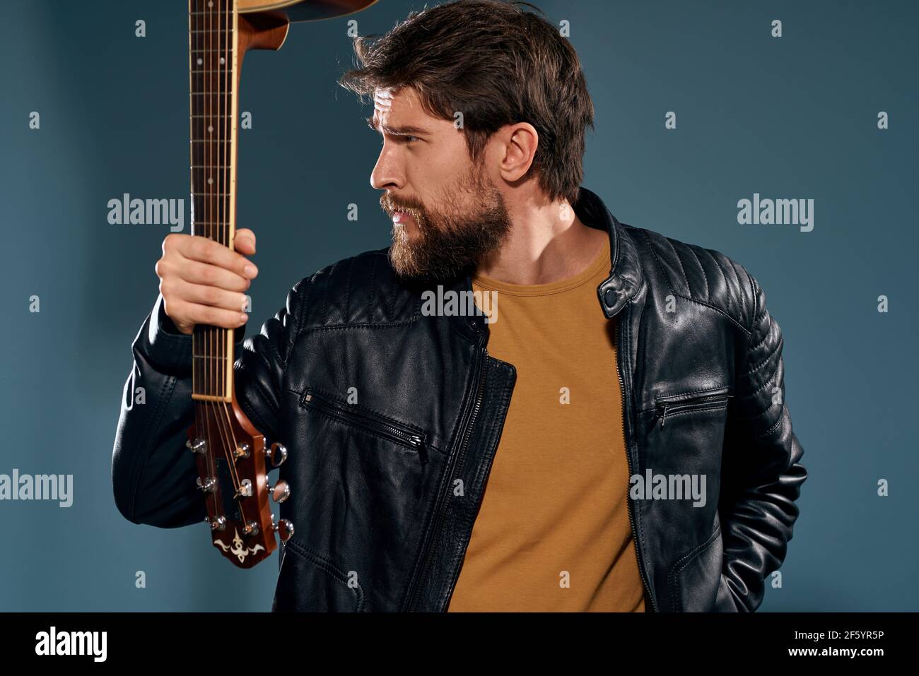 Male musician in leather jacket performed by musical group guitar Stock ...