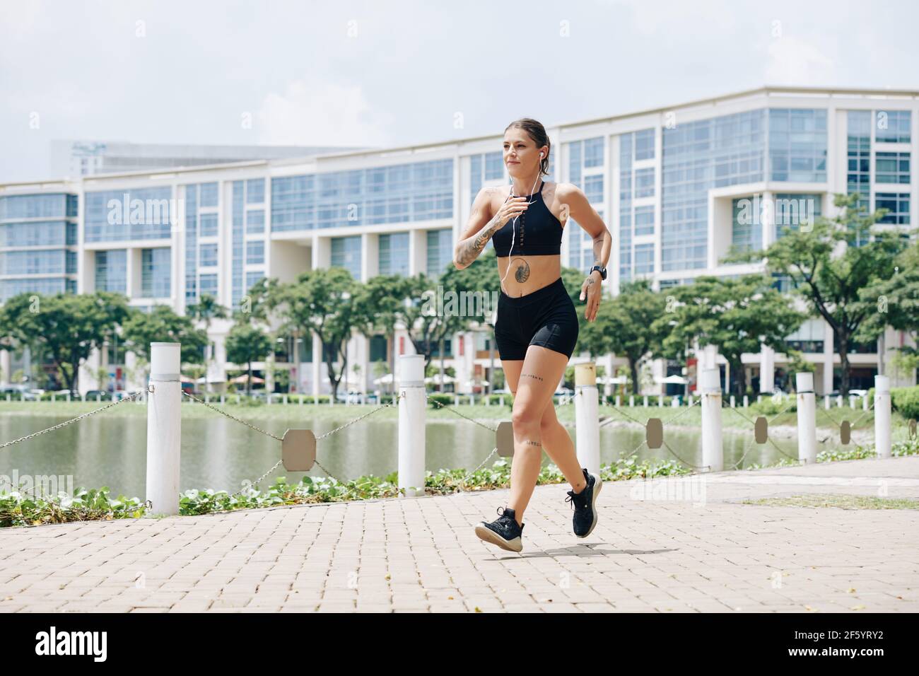 Fit positive young woman training for racewalking competition, she is ...