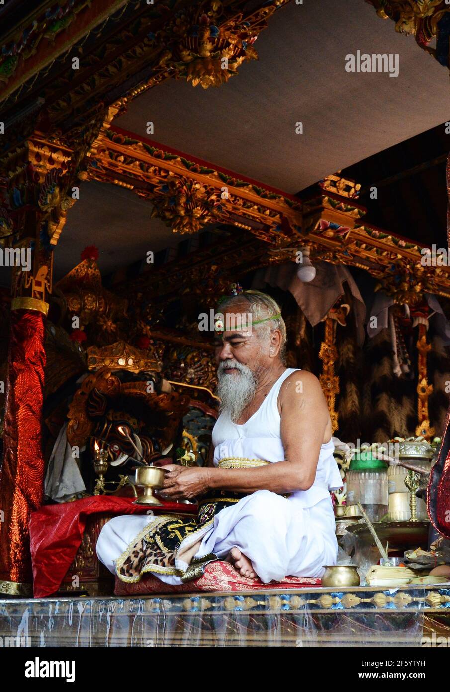A Balinese Hindu priest blessing a groom in a pre wedding ceremony in a ...