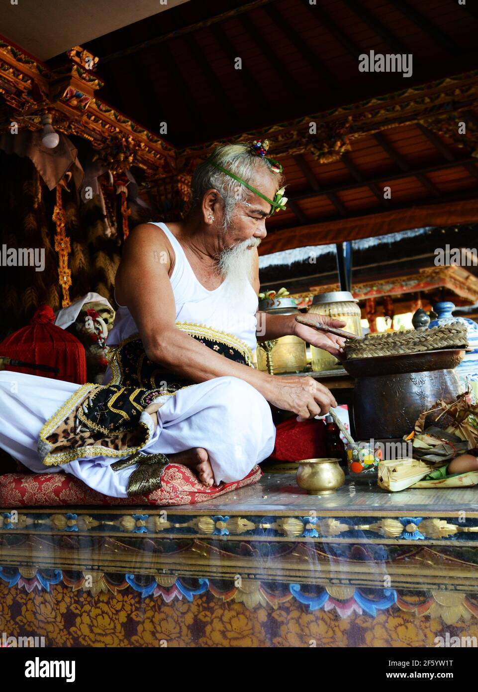 A Balinese Hindu priest blessing a groom in a pre wedding ceremony in a ...
