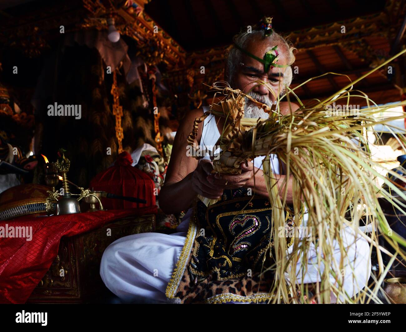 A Balinese Hindu priest blessing a groom in a pre wedding ceremony in a ...