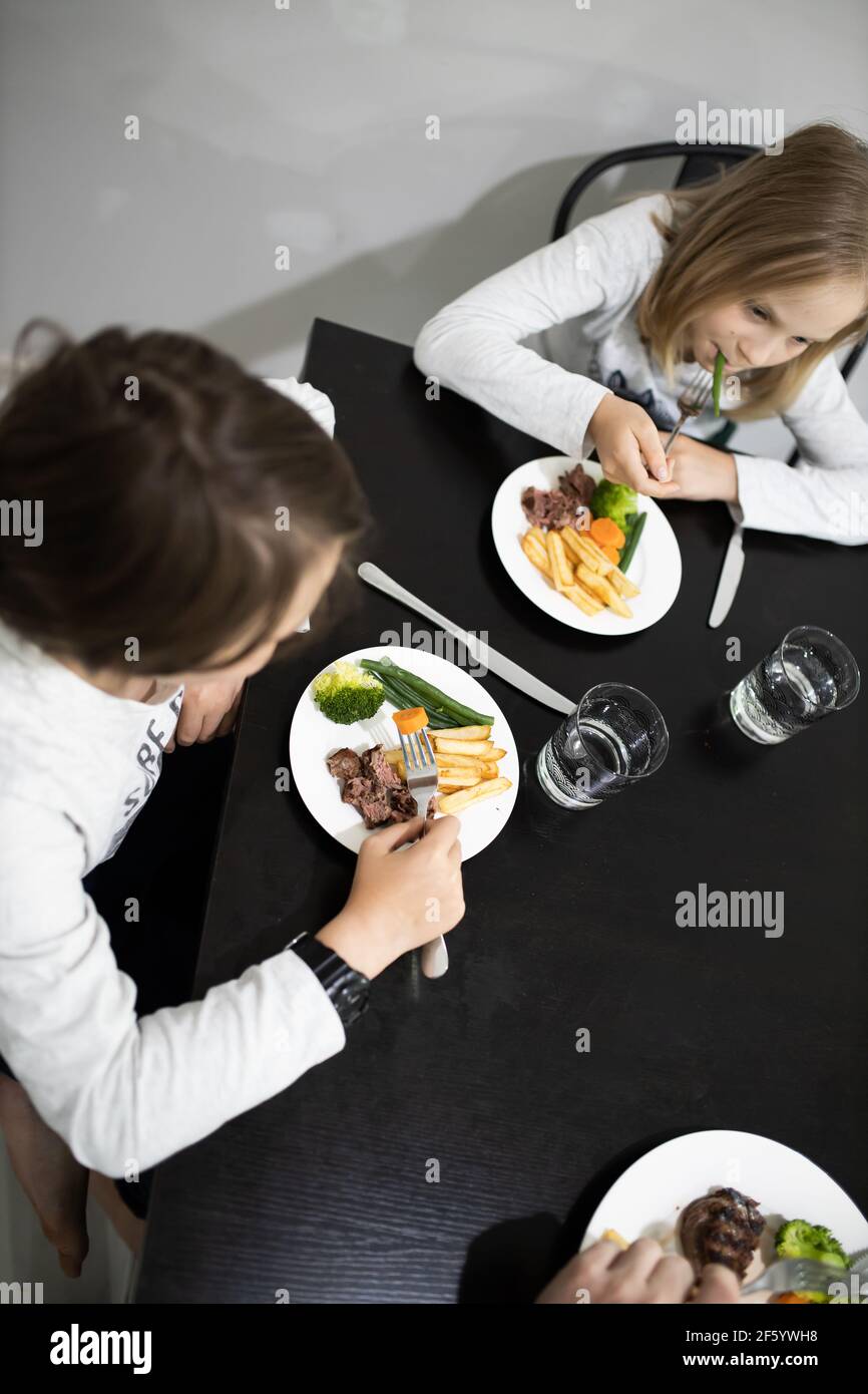 Family Eating a healthy Dinner at a table Stock Photo - Alamy