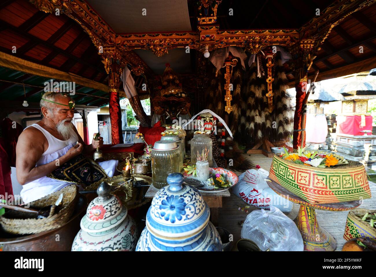 A Balinese Hindu priest blessing a groom in a pre wedding ceremony in a ...