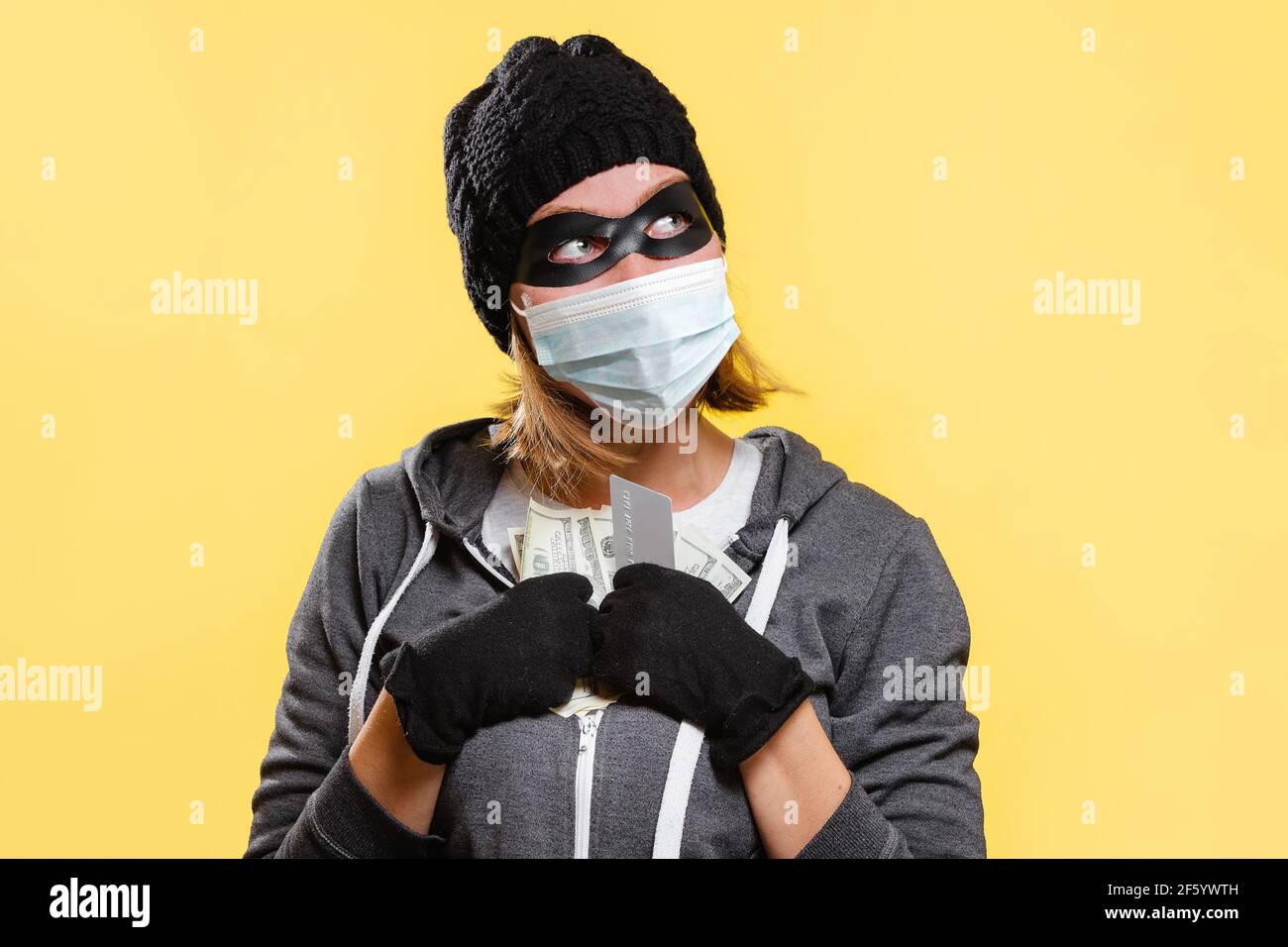 The new normal. A female hacker wearing a black hat, gloves, and ...