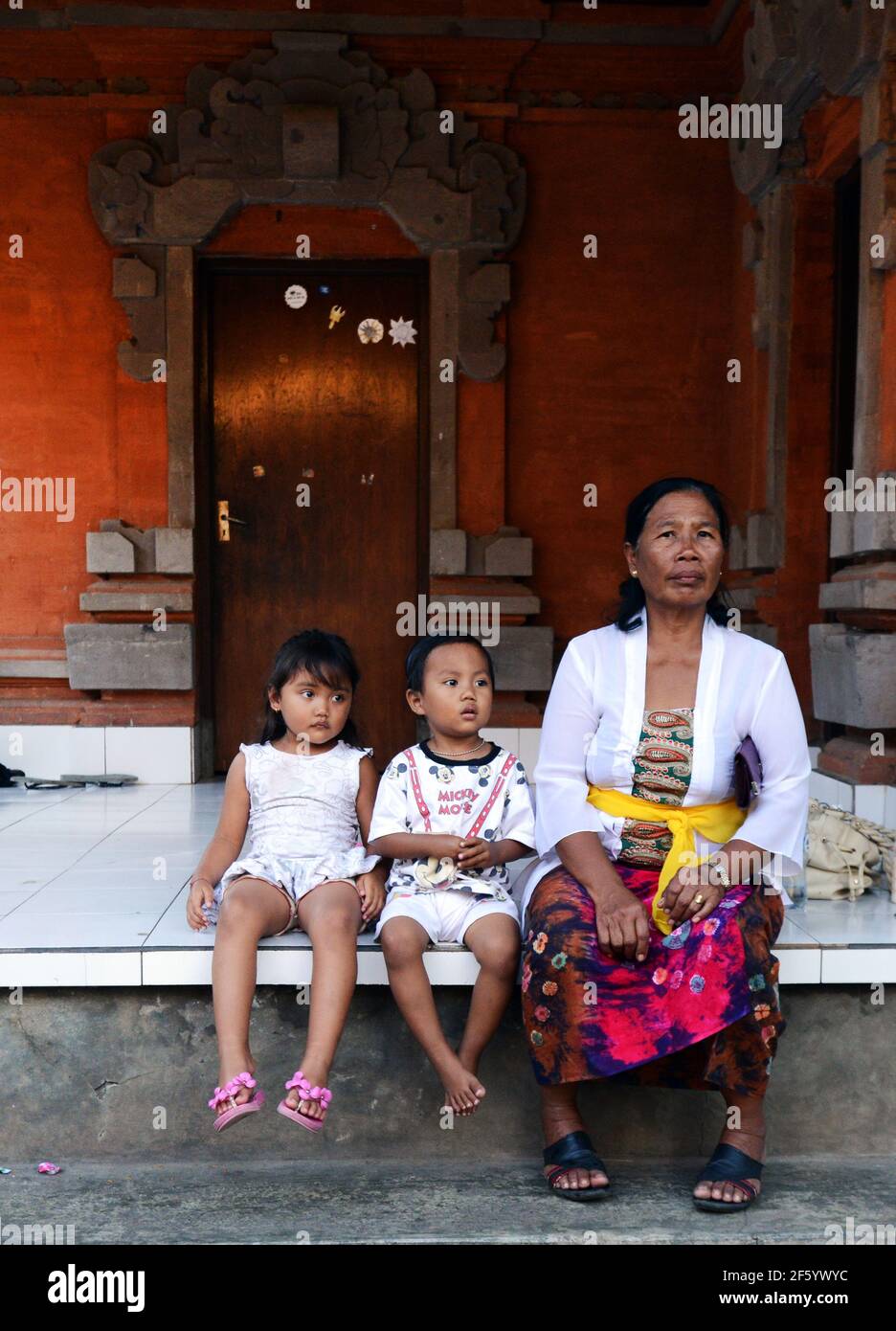 Balinese children with their grandmother Stock Photo - Alamy