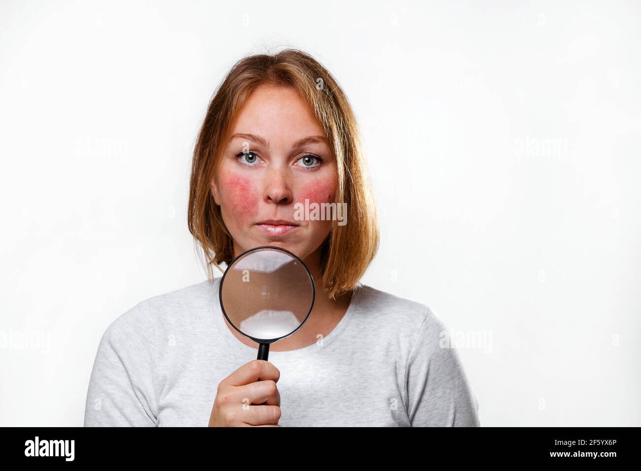 Surprised young woman magnifying glass hi-res stock photography and ...