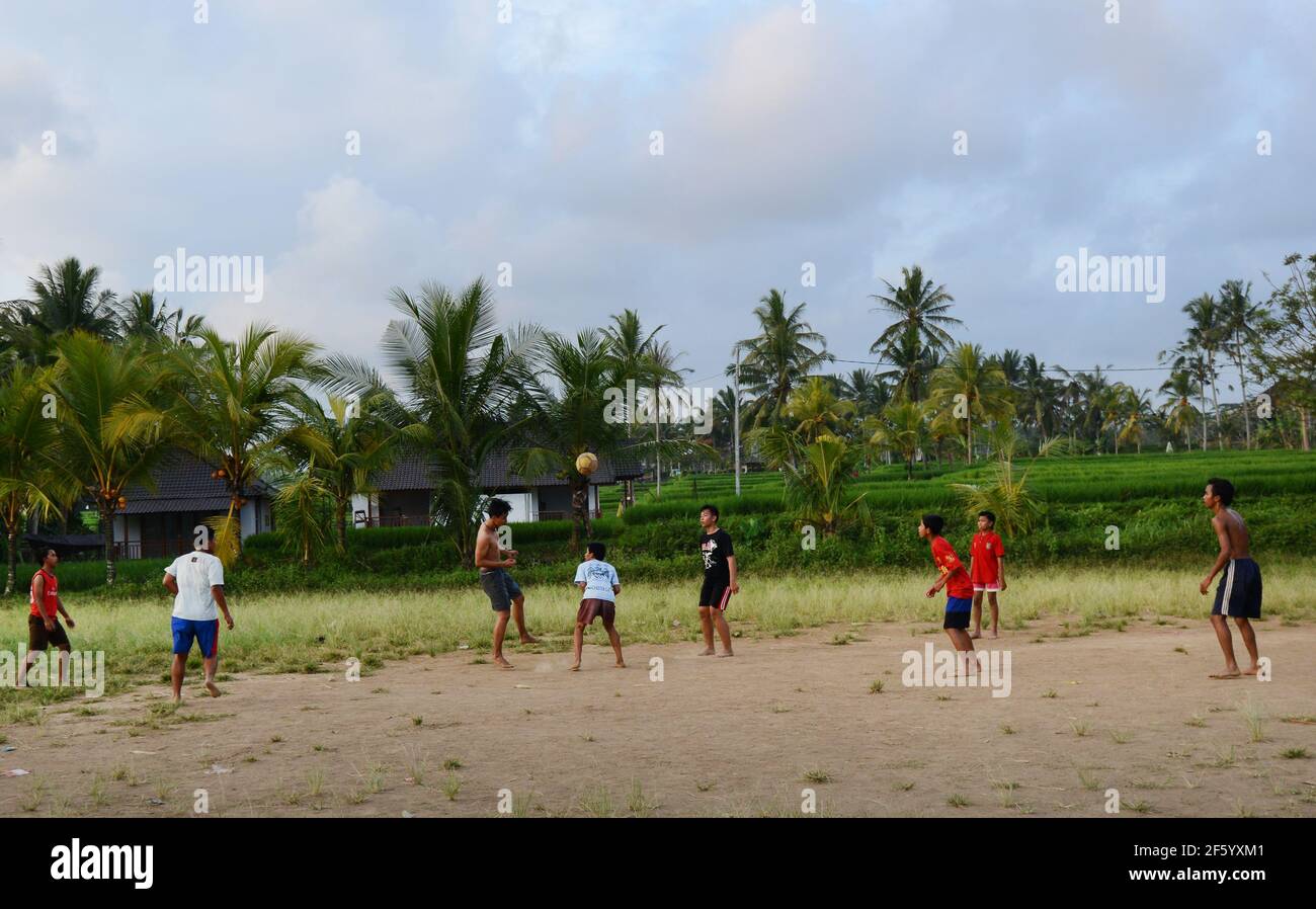 Balinese men playing football in their village near Ubud, Bali ...
