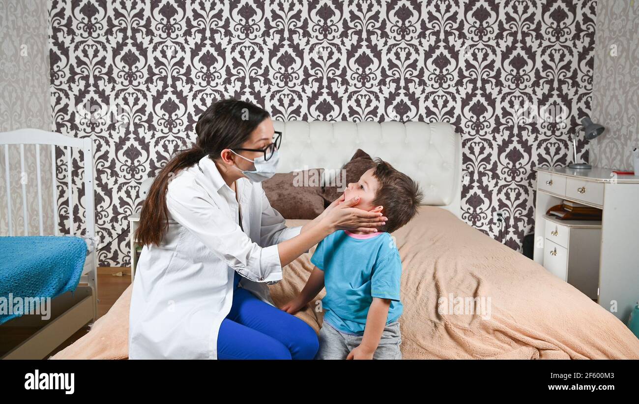 The doctor examines a sick child at home. High quality photo Stock ...