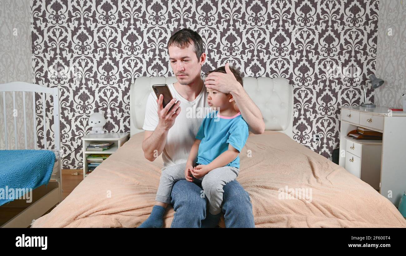 The father calls the clinic, calling the doctor at home. High quality ...